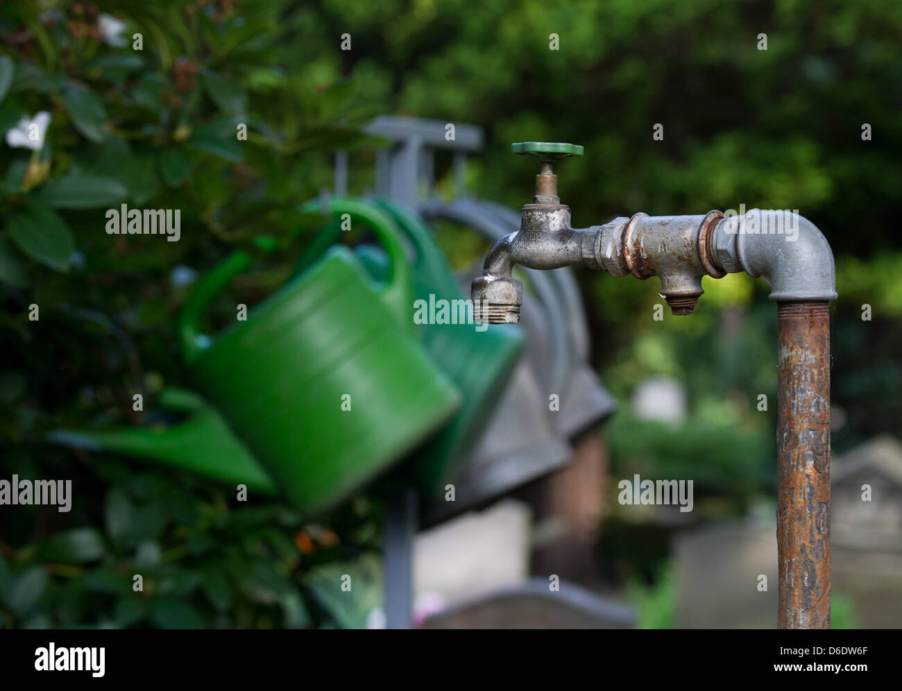 A rusty tap is visible in front of water cans at the Trinitatis ...