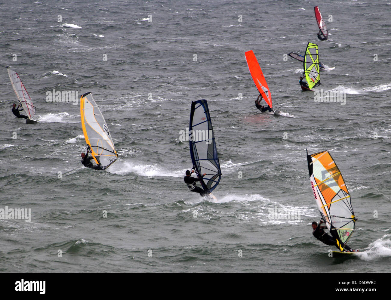 Surfers take advantage of the weather behind a jetty on the Baltic Sea ...