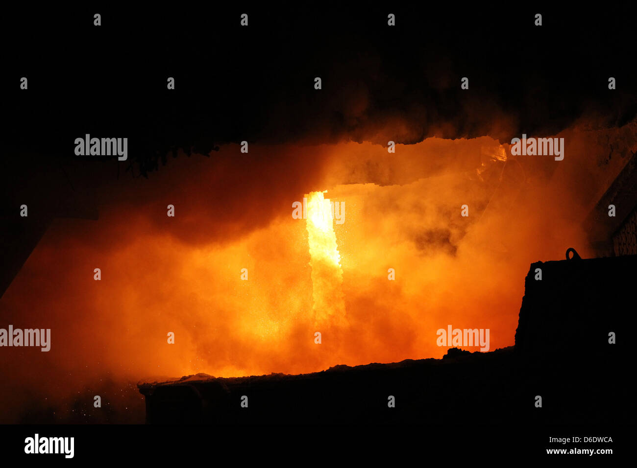 Liquid steel flows from a furnace into a steel lable at the ...