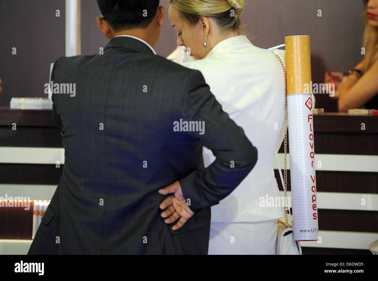 A visitor carries a bag in the shape of a cigarette at the "inter-tabac ...