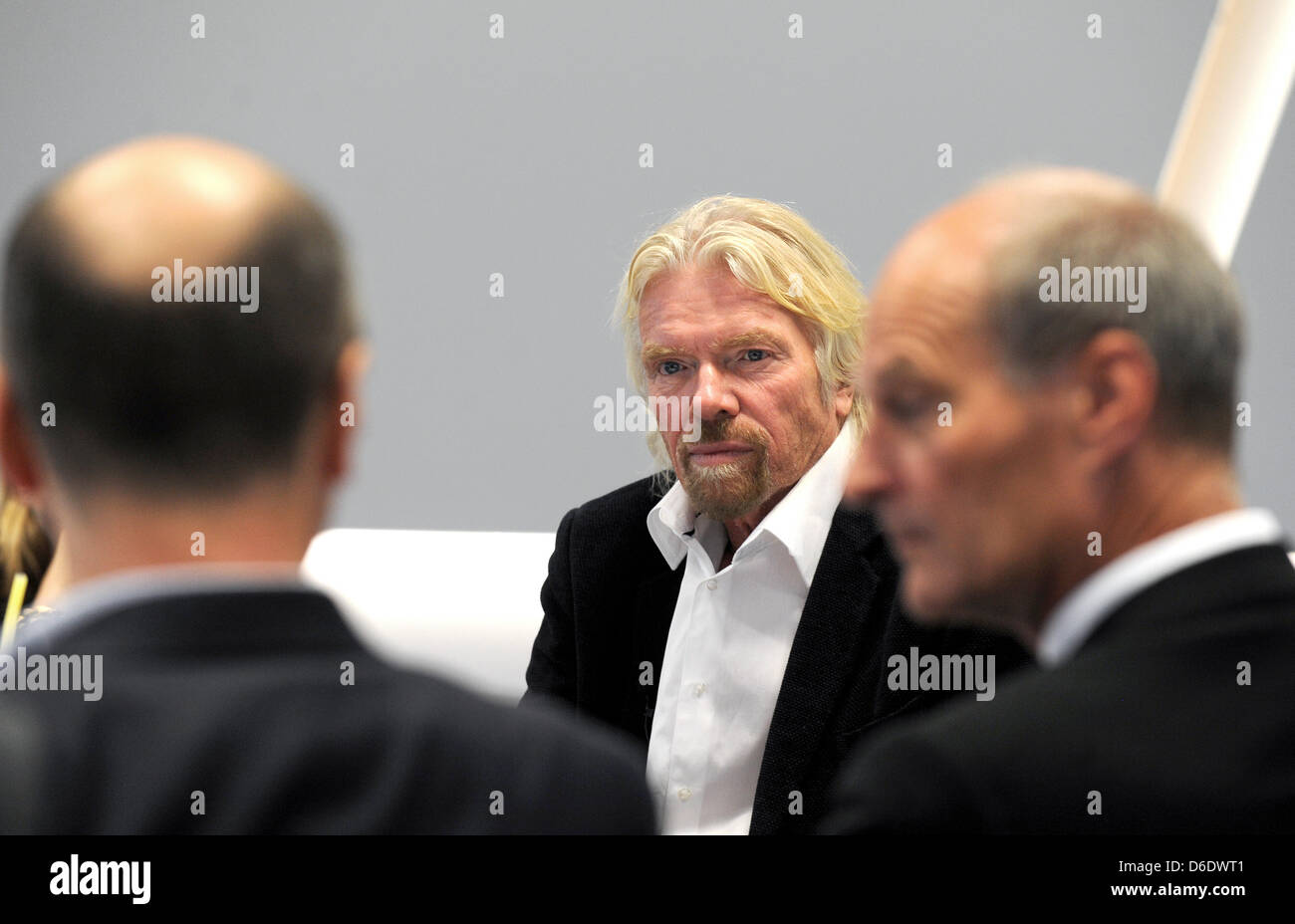 British billionaire Sir Richard Branson (C) attends a talk with ...