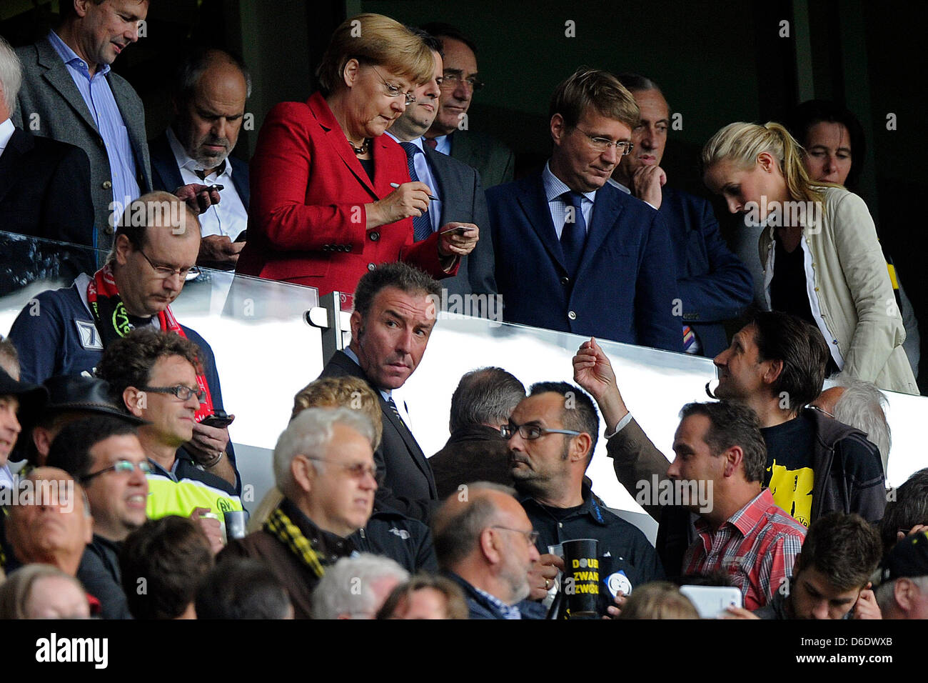 German Chancellor Angela Merkel signs autographs before the start of ...