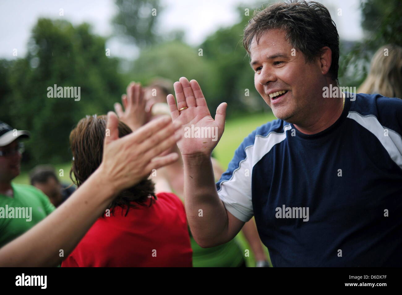 Boot camp participant Holger Temme clasps hands after finishing a ...