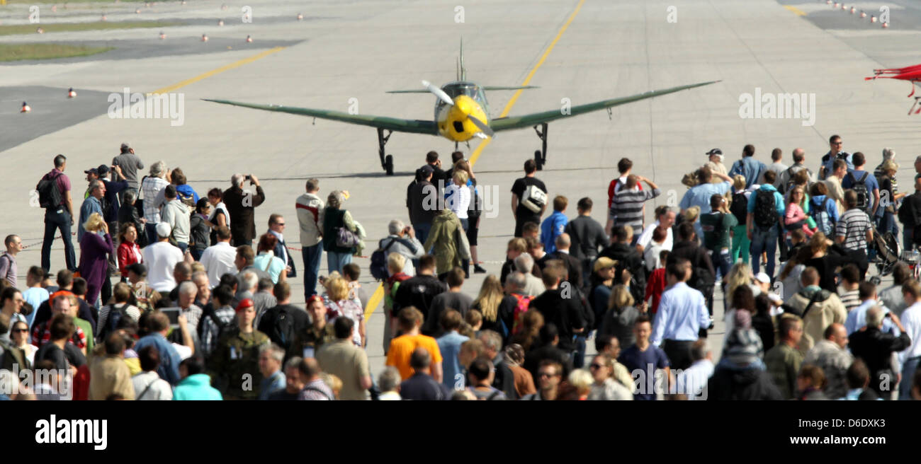 People watch a Messerschmidt Me 208 flight demonstration during the ...