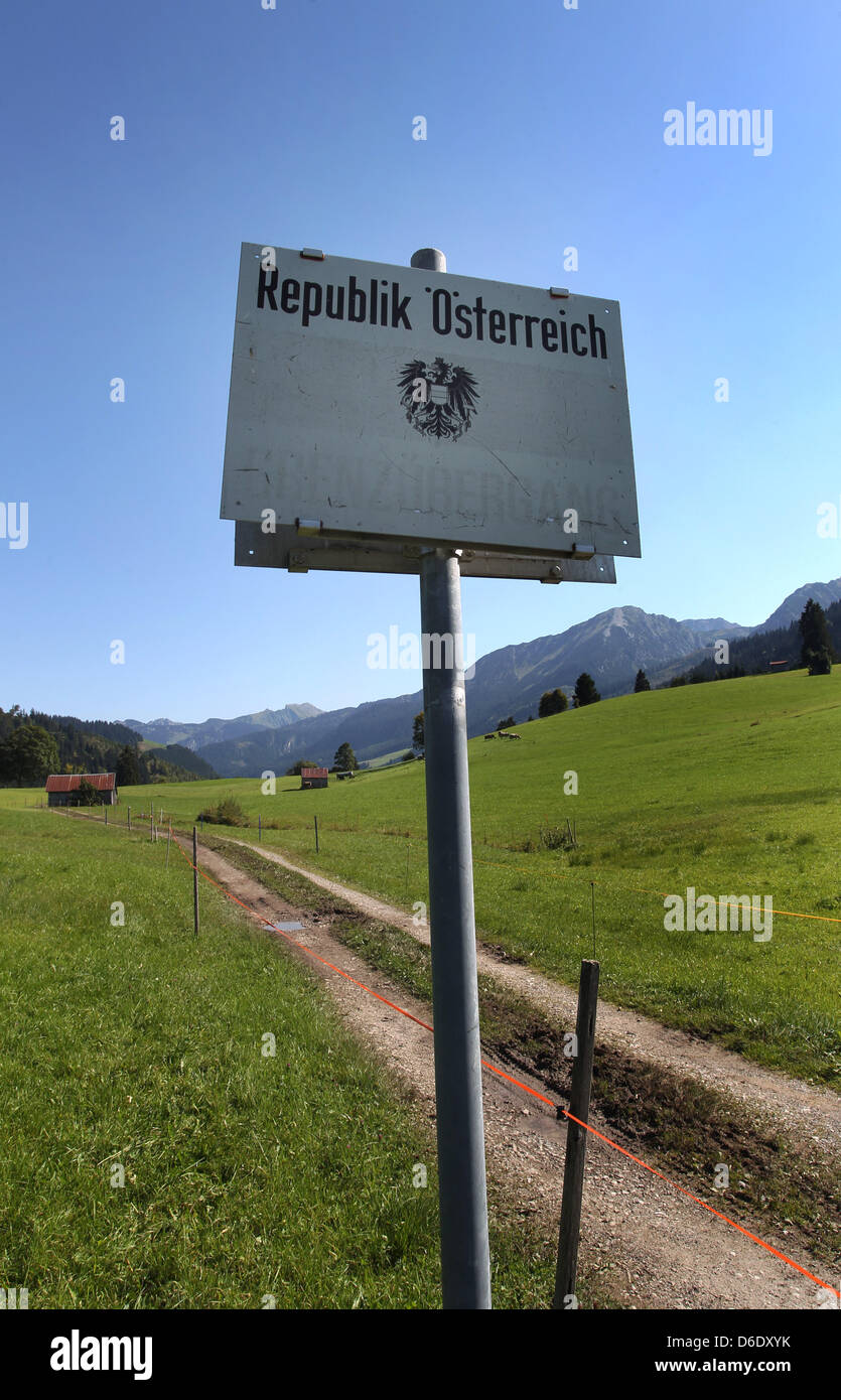 A sign on a path marks the border between Germany and Austria pictured ...