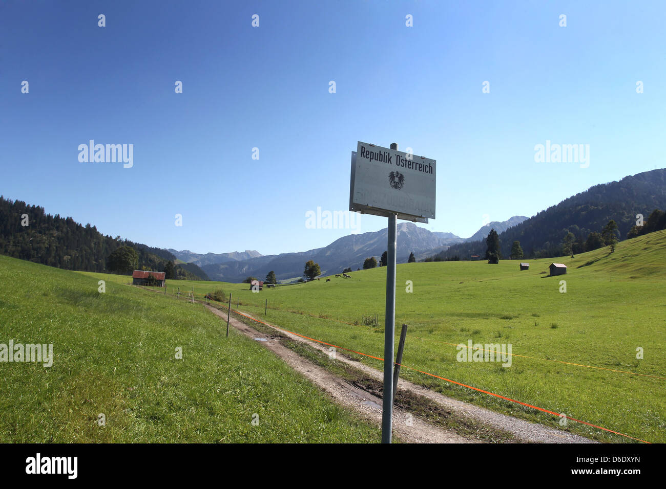 A sign on a path marks the border between Germany and Austria pictured ...
