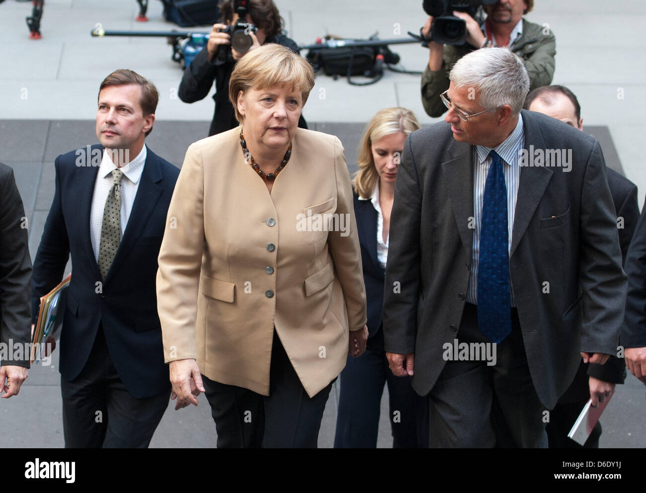 German Chancellor Angela Merkel walks next to Gregor Mayntz (R ...