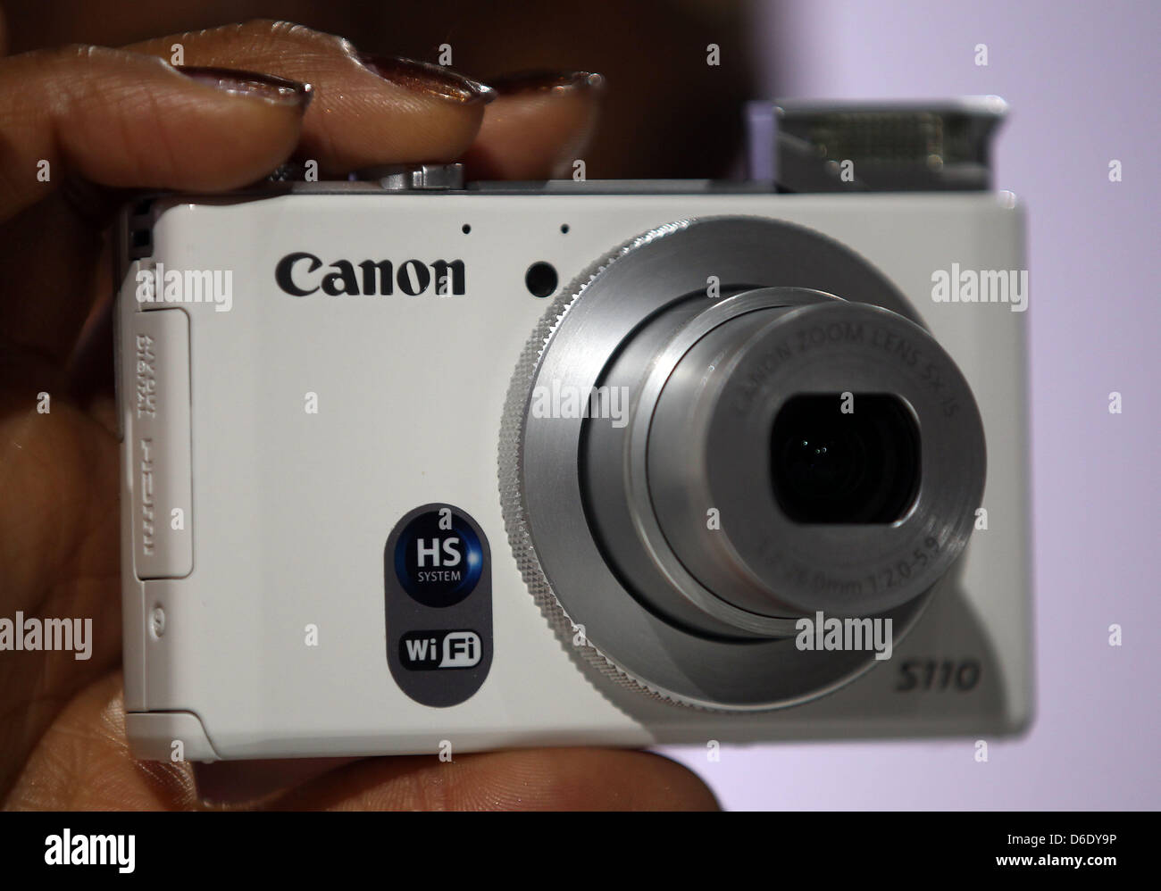 A Canon employee presents the Canon S 110 camera at the photography ...