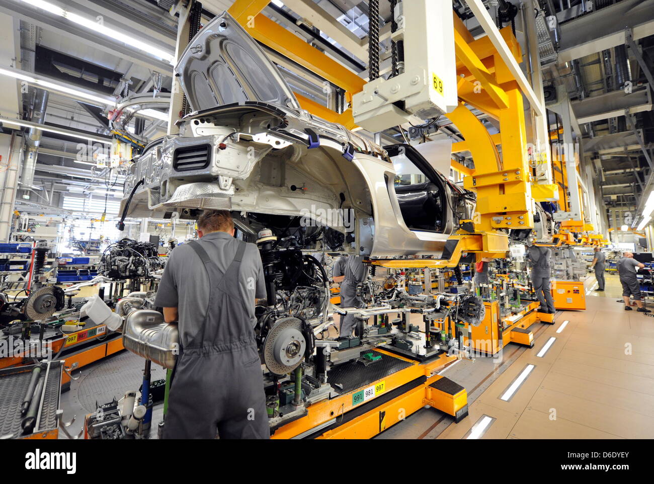 Porsche employees assemble cars at the manufacturing plant in Stuttgart ...