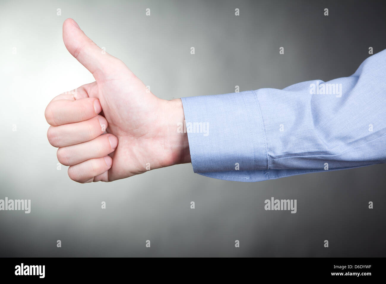 Man gesturing approval thumbs up sign Stock Photo - Alamy