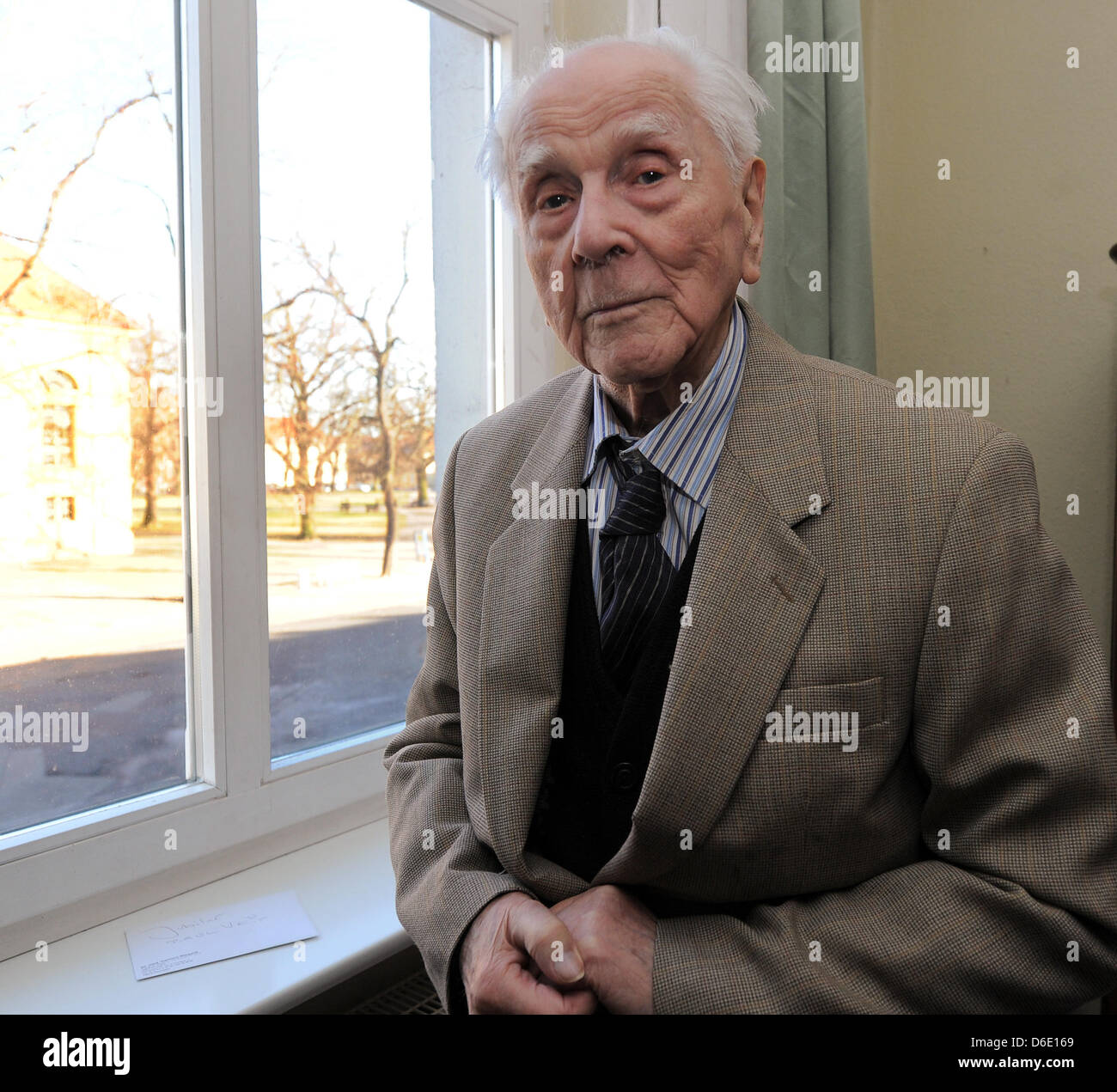 109 year old Paul Veit stands net to his favorite chair in his flat in ...