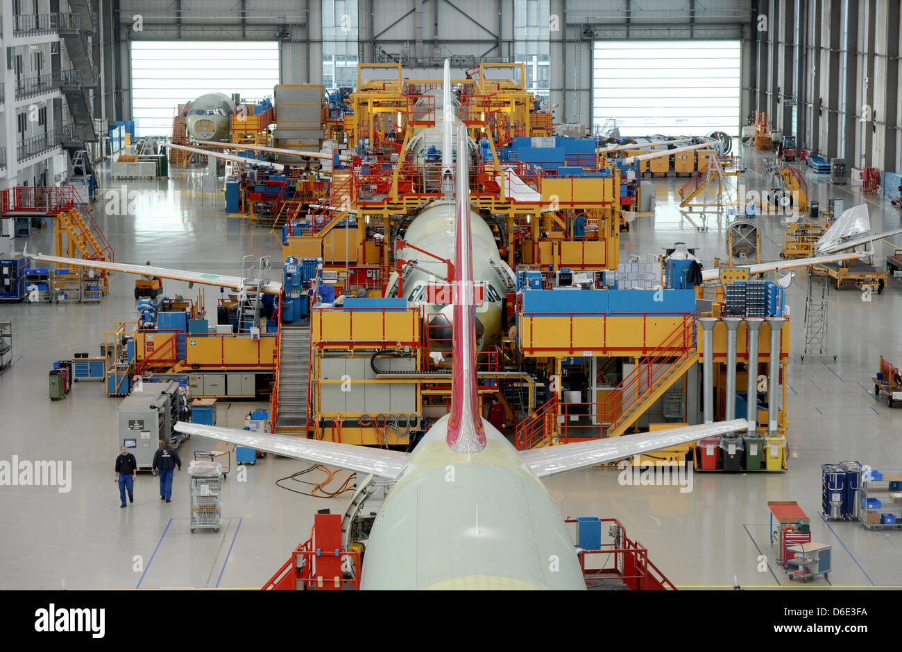 Skilled personnel work on aircraft at the A320 final assembly hangar at ...