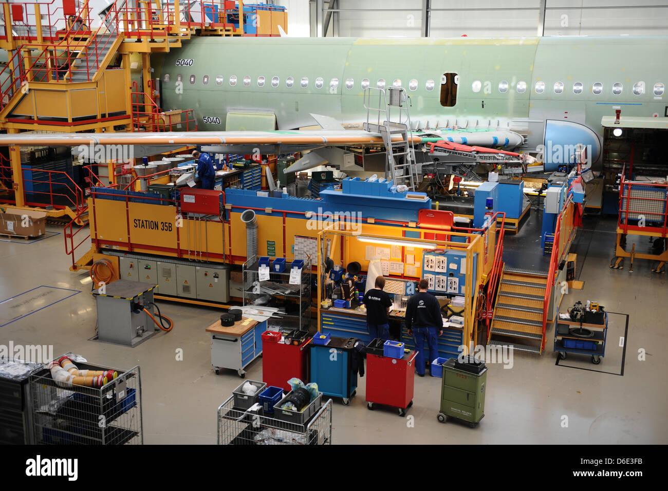 Skilled personnel work on aircraft at the A320 final assembly hangar at ...