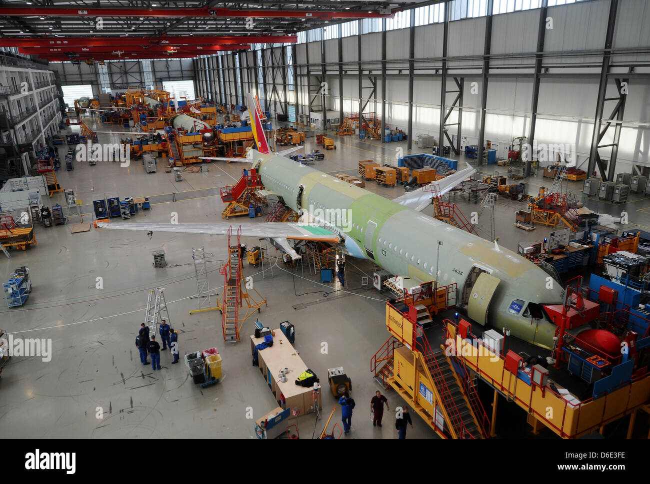 Skilled personnel work on aircraft at the A320 final assembly hangar at ...