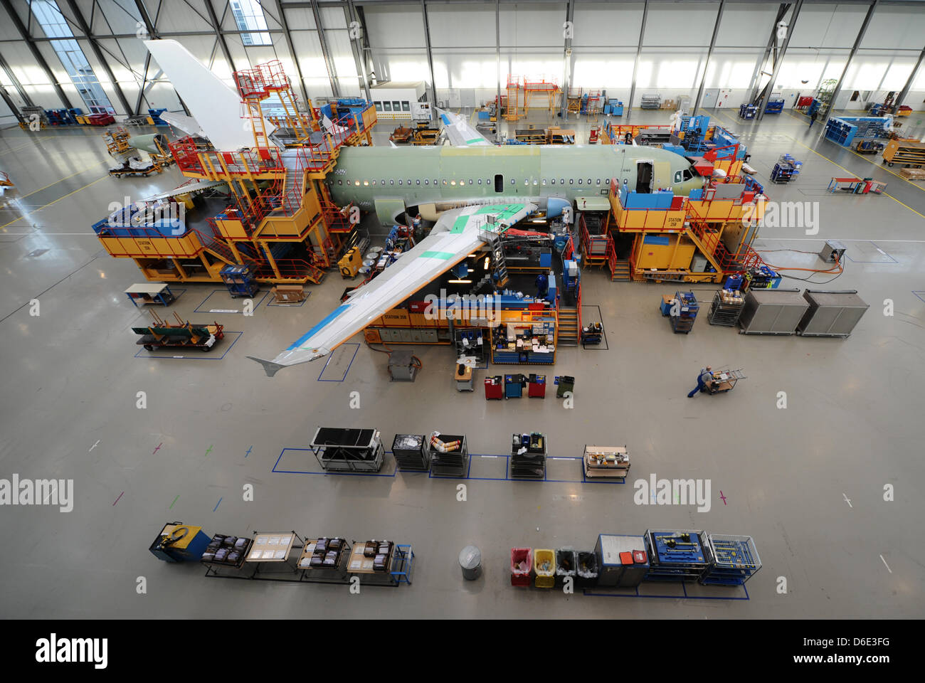 Skilled personnel work on aircraft at the A320 final assembly hangar at ...