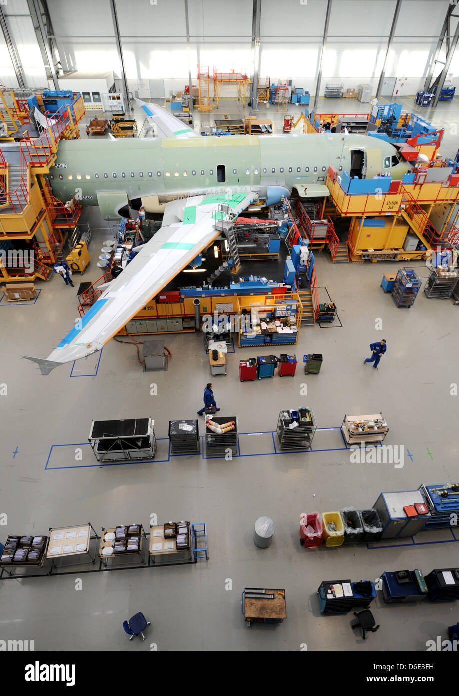 Skilled personnel work on aircraft at the A320 final assembly hangar at ...