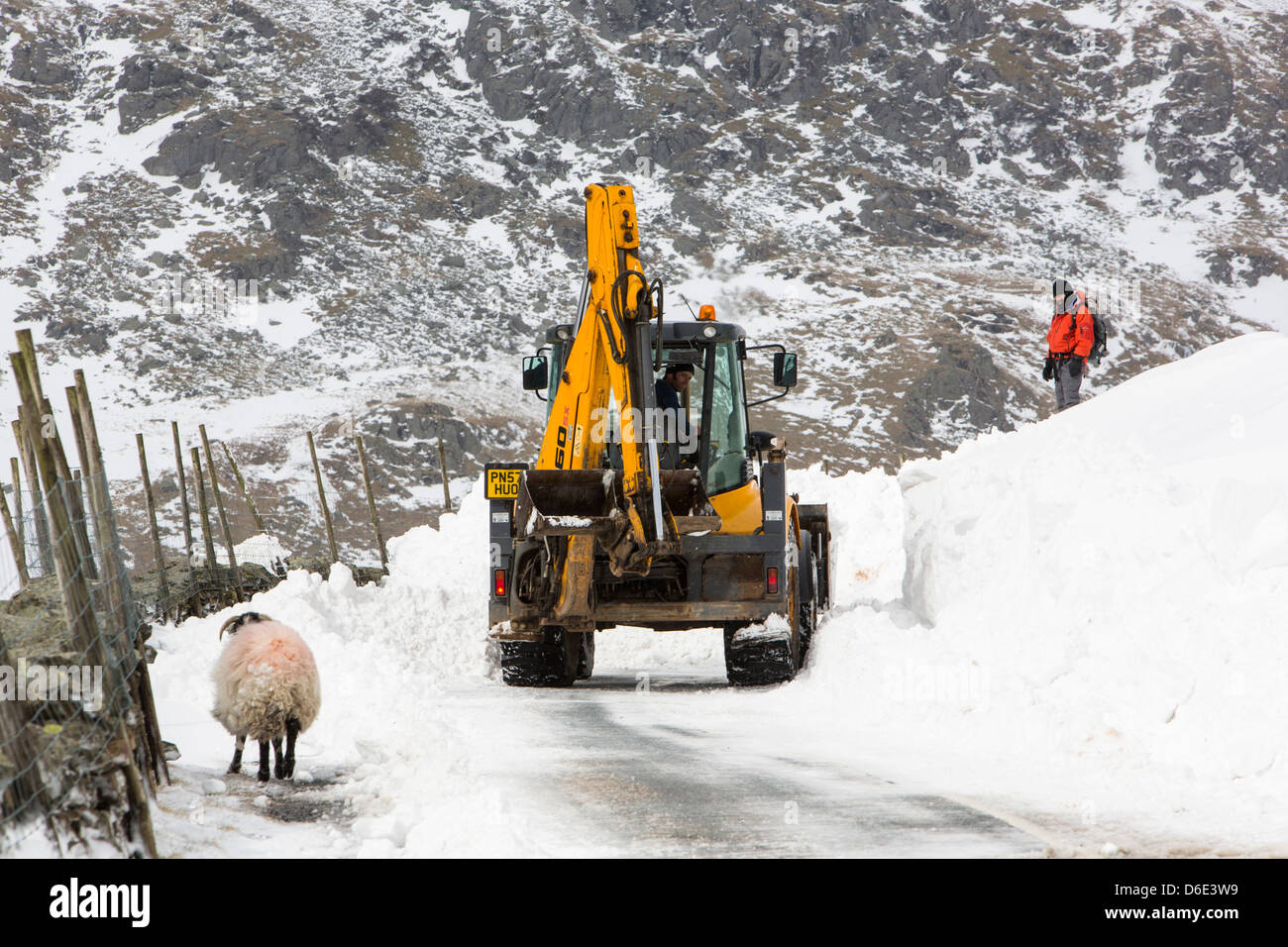 A JCB tries to clear a way through massive snow drifts blocking the ...
