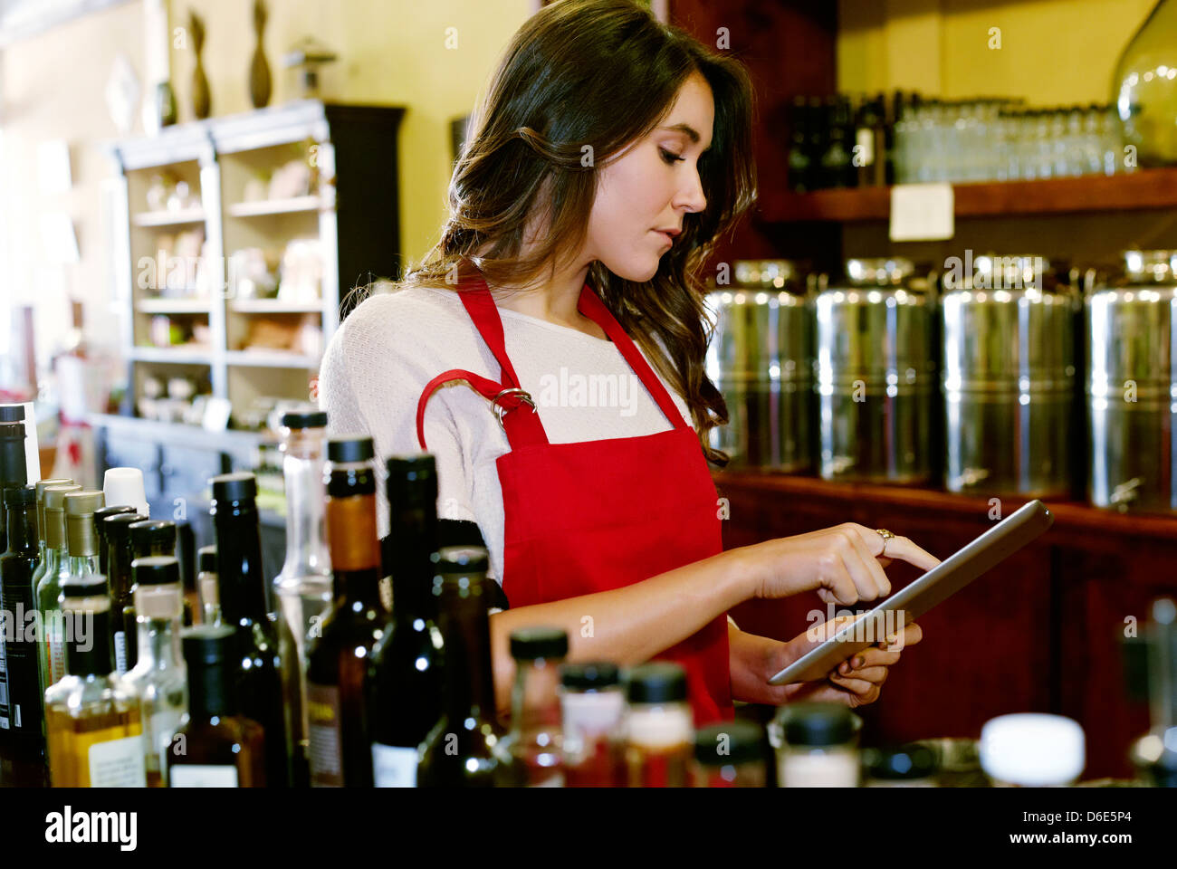 Woman working in grocery store Stock Photo - Alamy