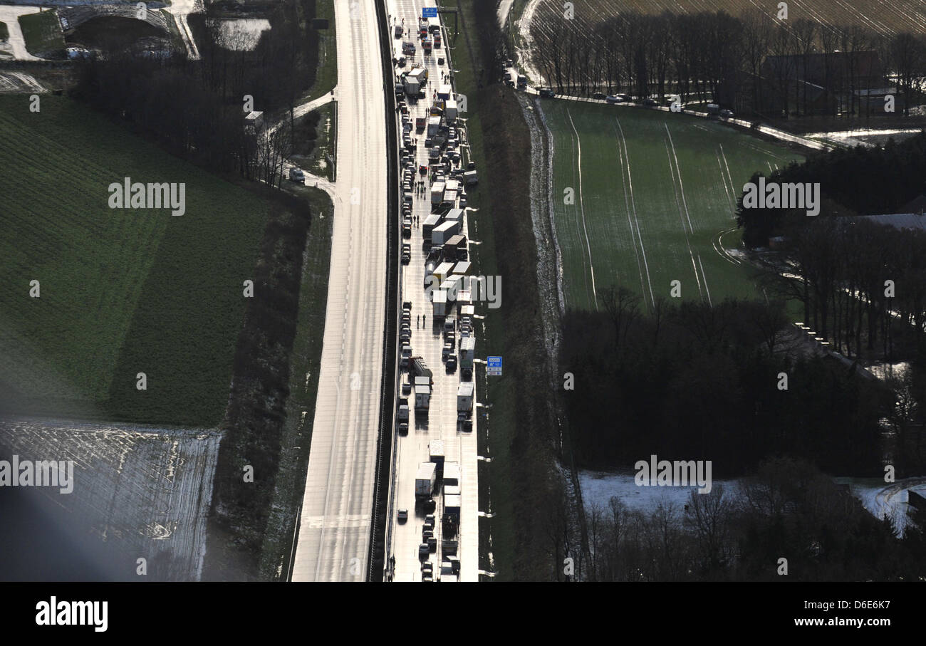Wrecked cars and trucks sit at the front of a multiple vehichle ...