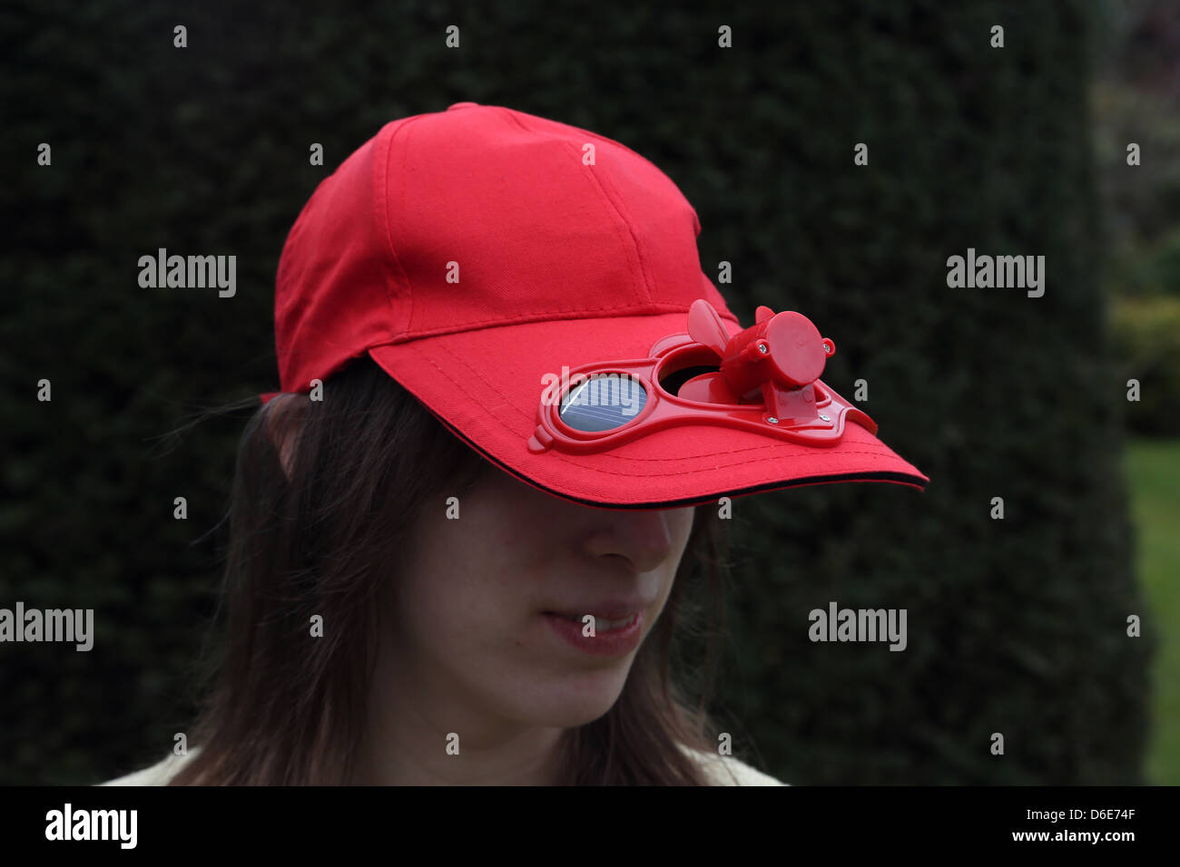 Woman Wearing Red Baseball Cap With Solar Powered Fan Stock Photo - Alamy