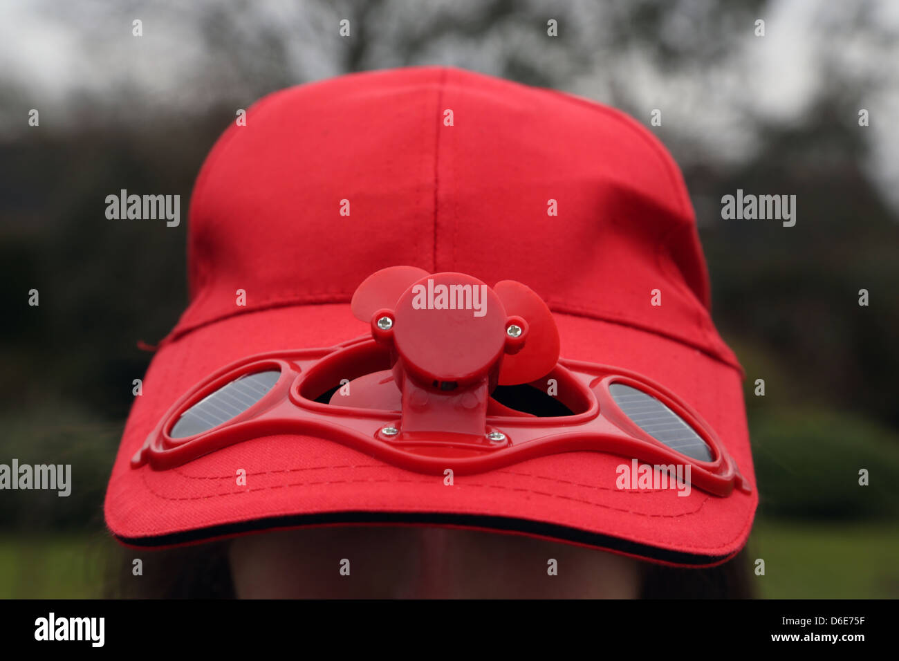 Woman Wearing Red Baseball Cap With Solar Powered Fan Stock Photo - Alamy
