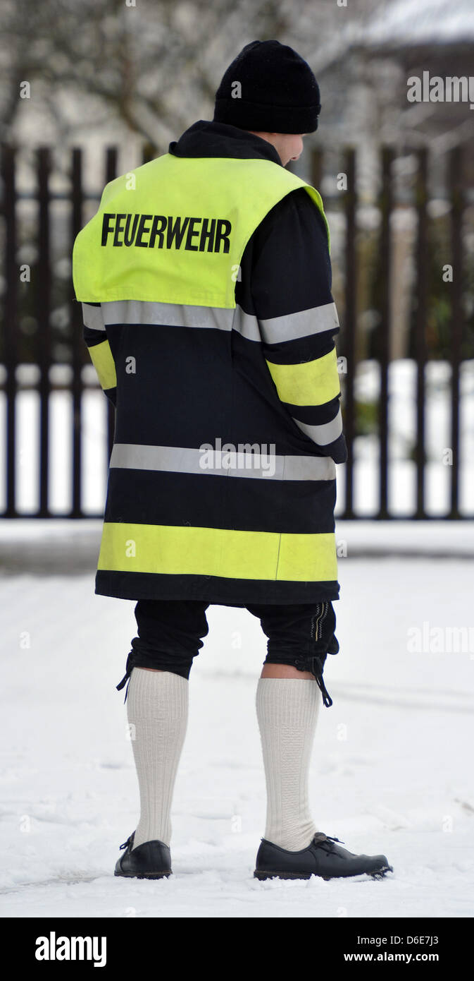 A fireman wears lederhosen under his uniform jacket during the "winter ...