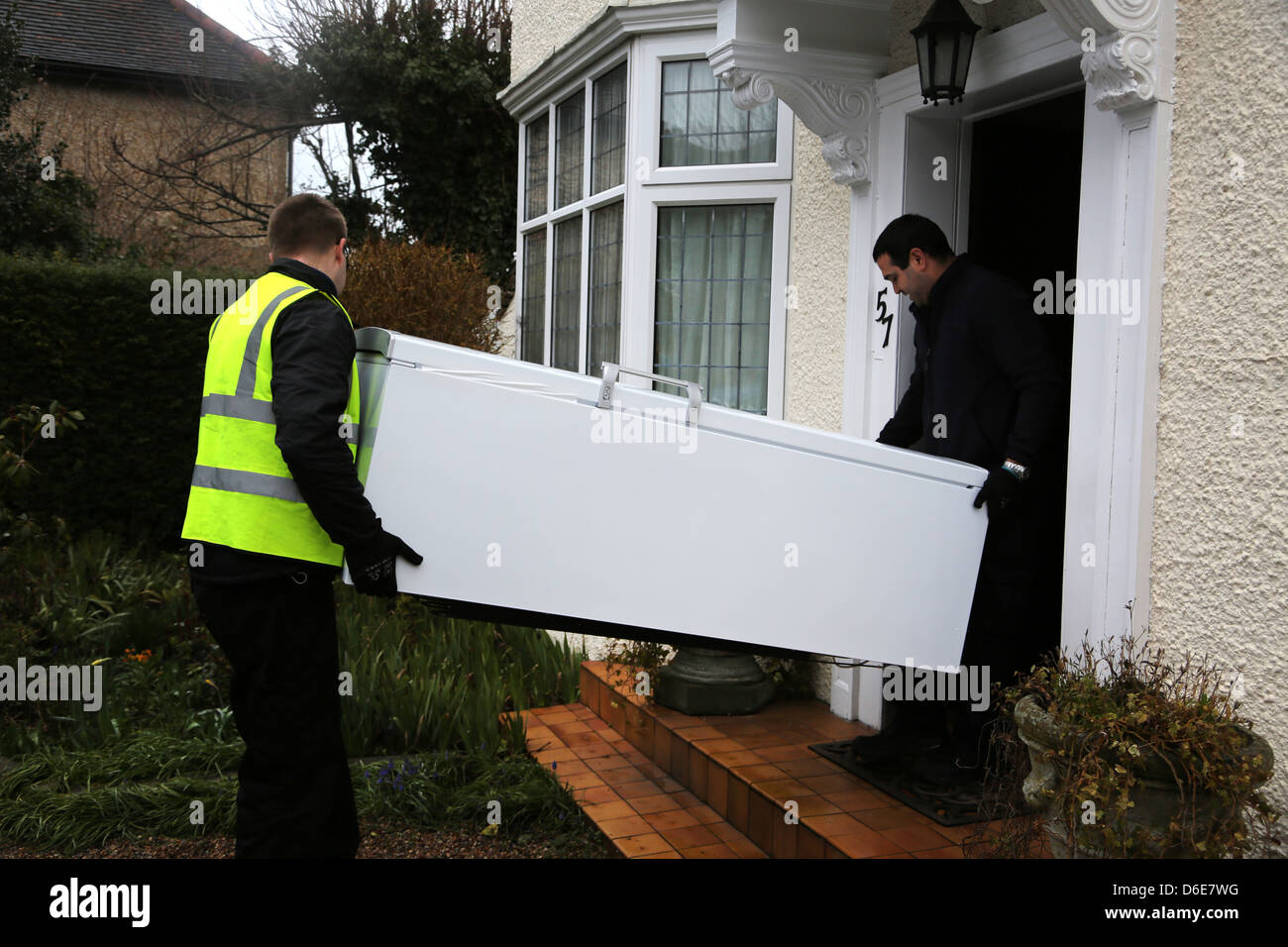 Delivering A Freezer Men Lifting a Heavy Freezer into a home England ...