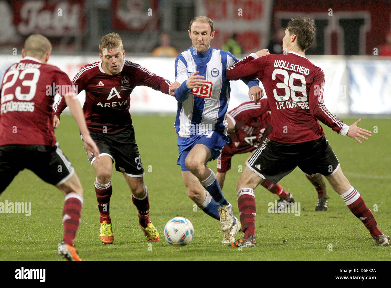 Nuremberg's Alexander Esswein (2-L) and Philipp Wollscheid (R) vie for ...