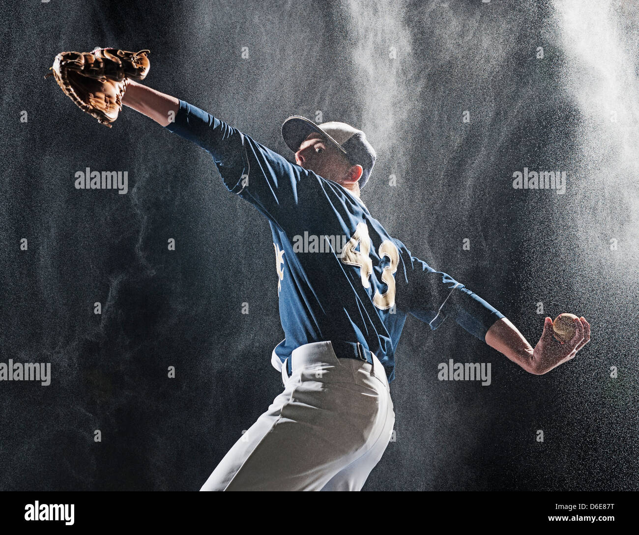 Caucasian baseball player pitching in rain Stock Photo - Alamy