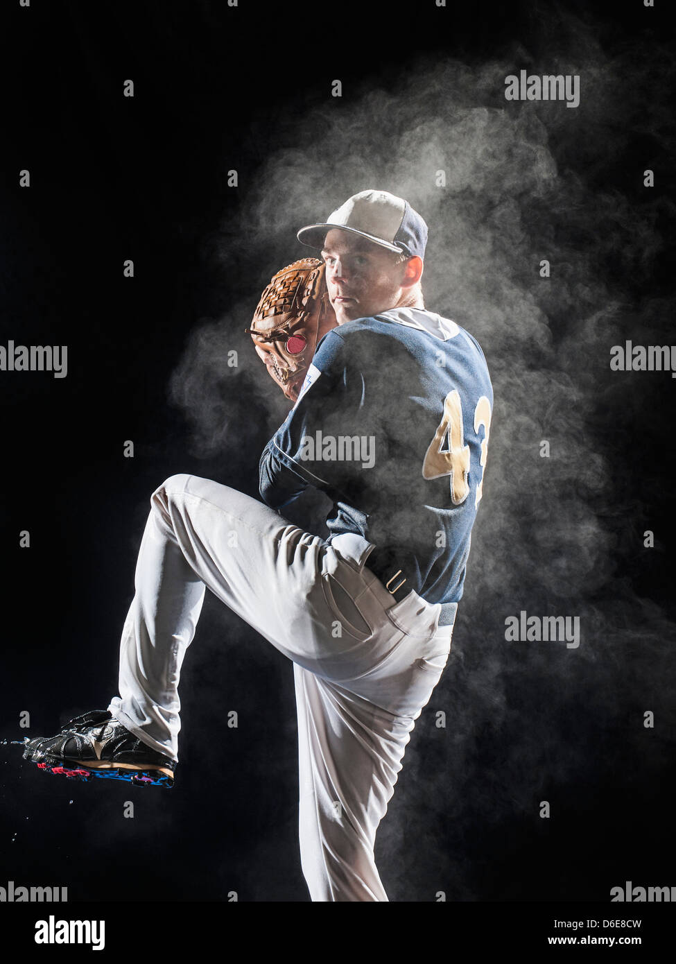 Caucasian baseball player pitching under lights Stock Photo - Alamy