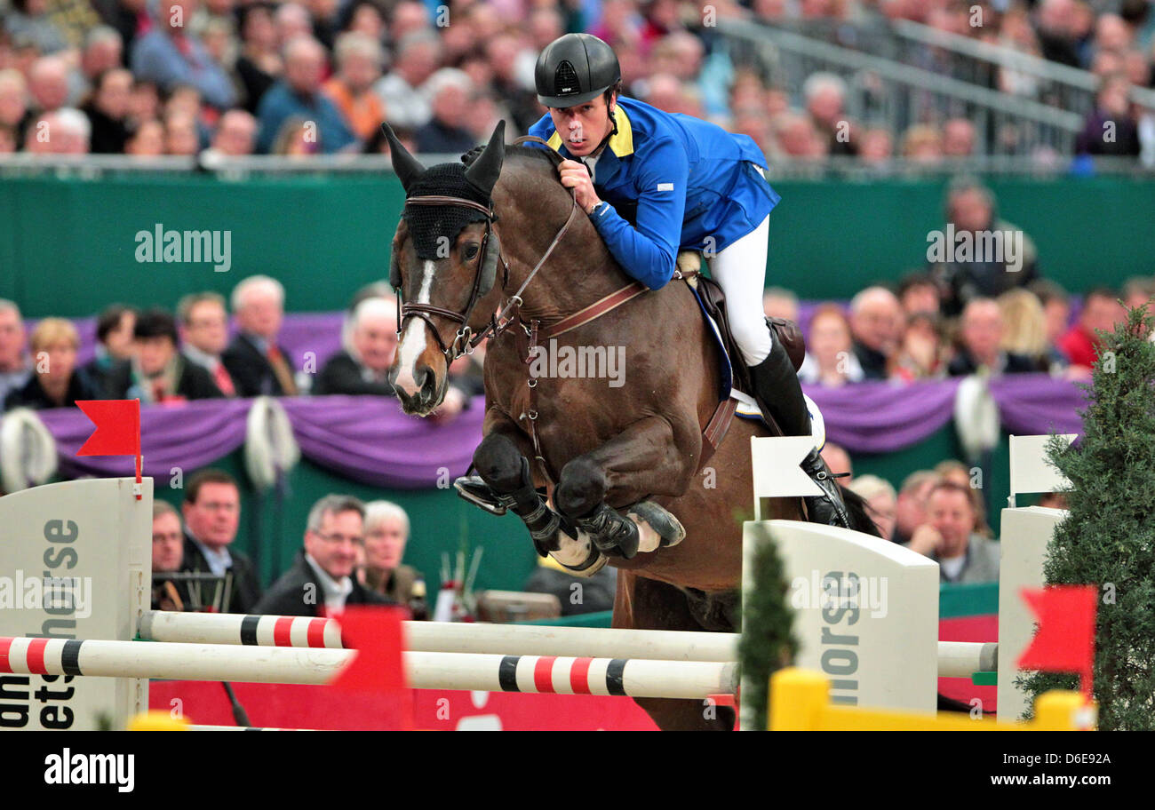 German show jumper Christian Ahlmann in action on his horse Taloubet at ...