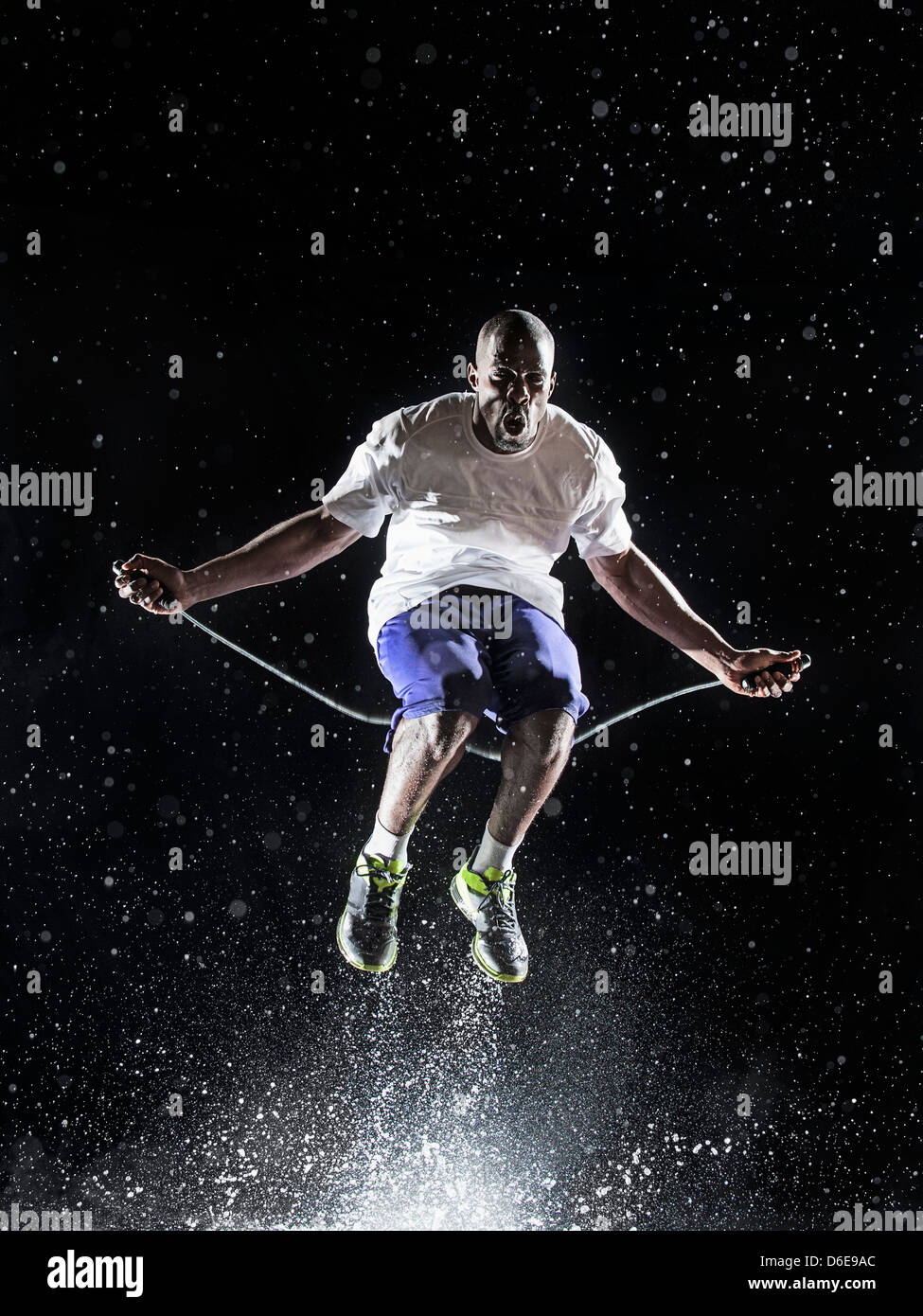 African American athlete jumping rope in puddle Stock Photo - Alamy