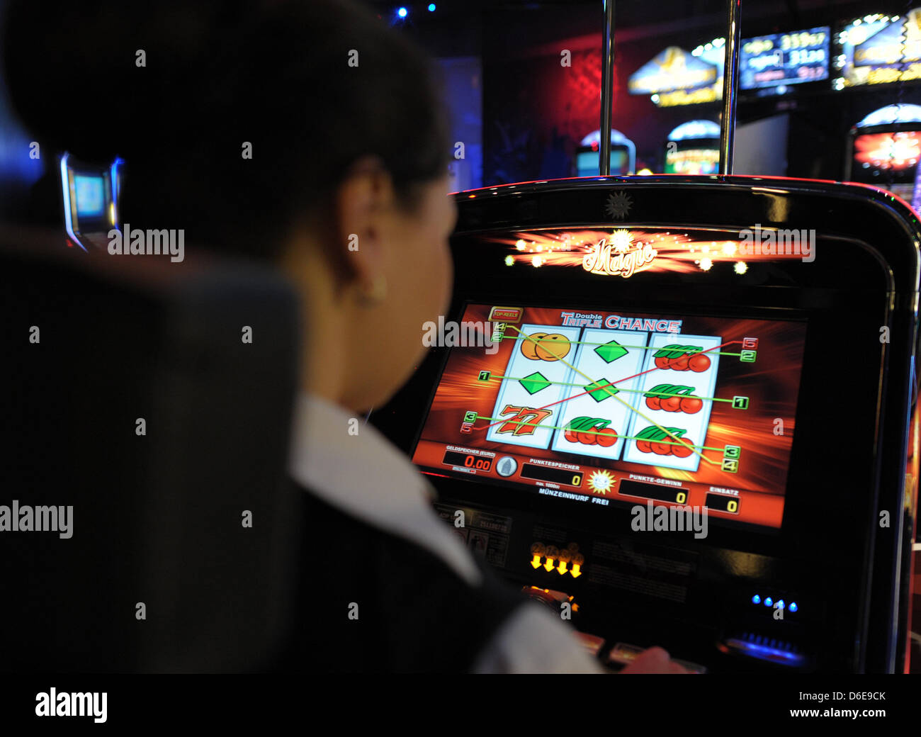 A staff member of the Merkur amusement arcade sits in front of a slot ...