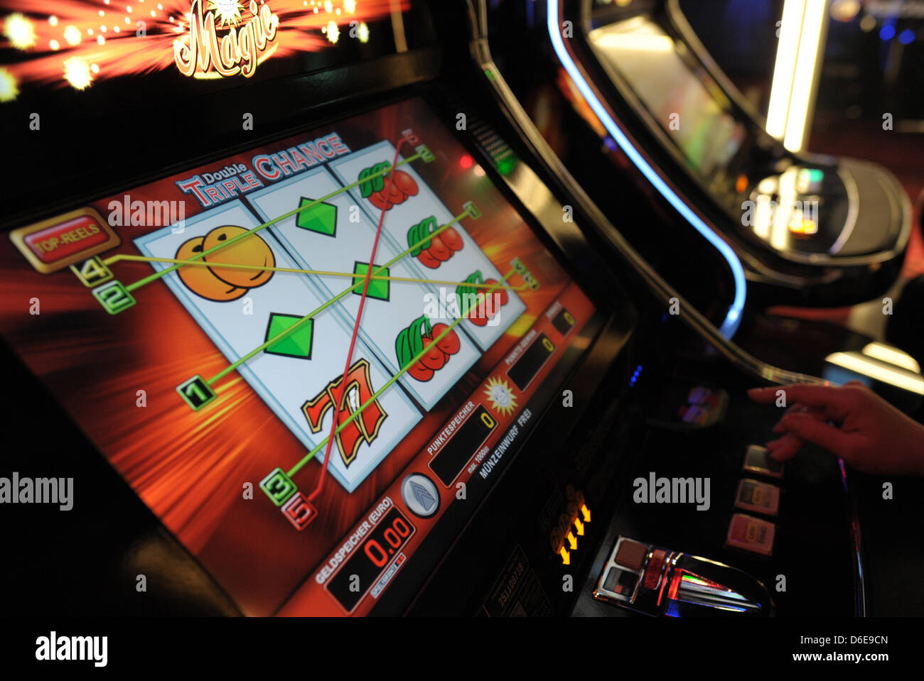 A staff member of the Merkur amusement arcade sits in front of a slot ...