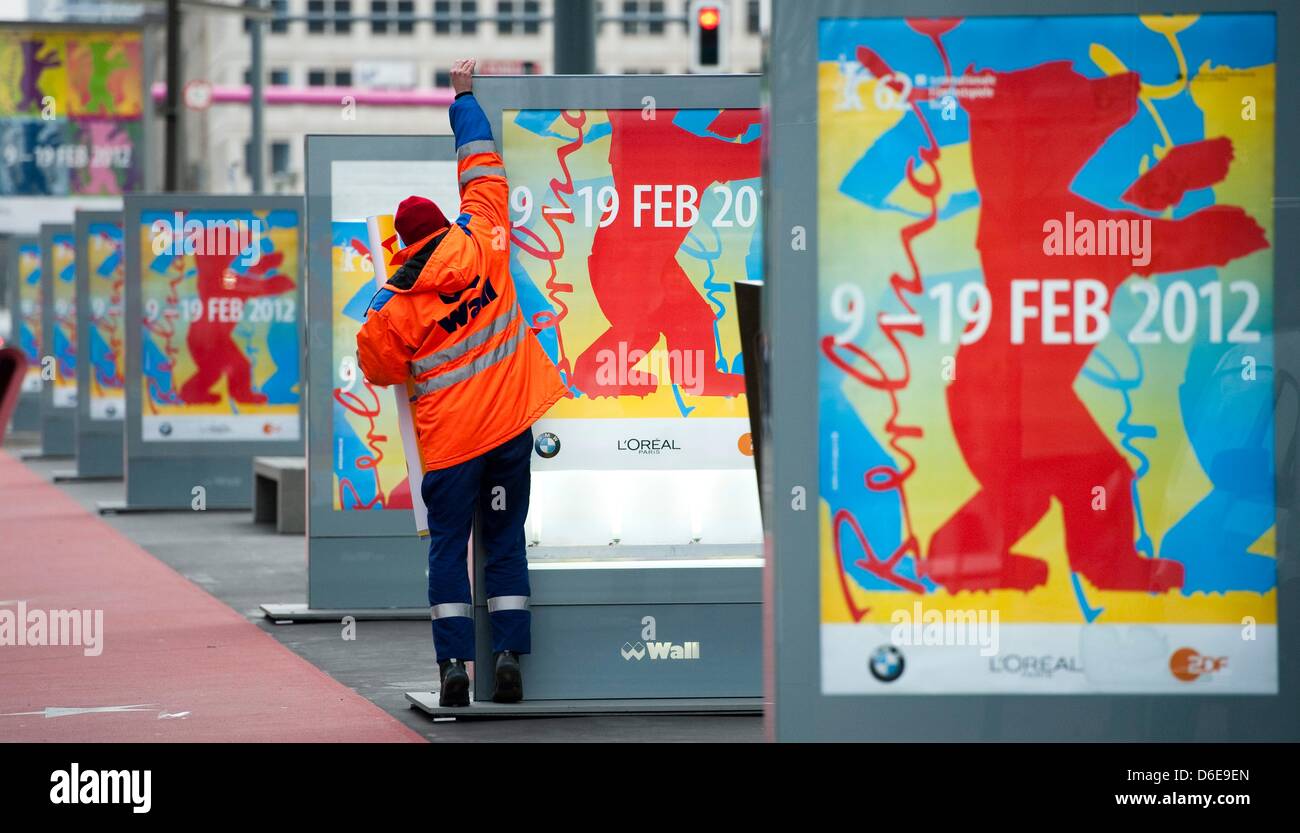 A staff member of the outdoor advertising company Wall AG equips ...