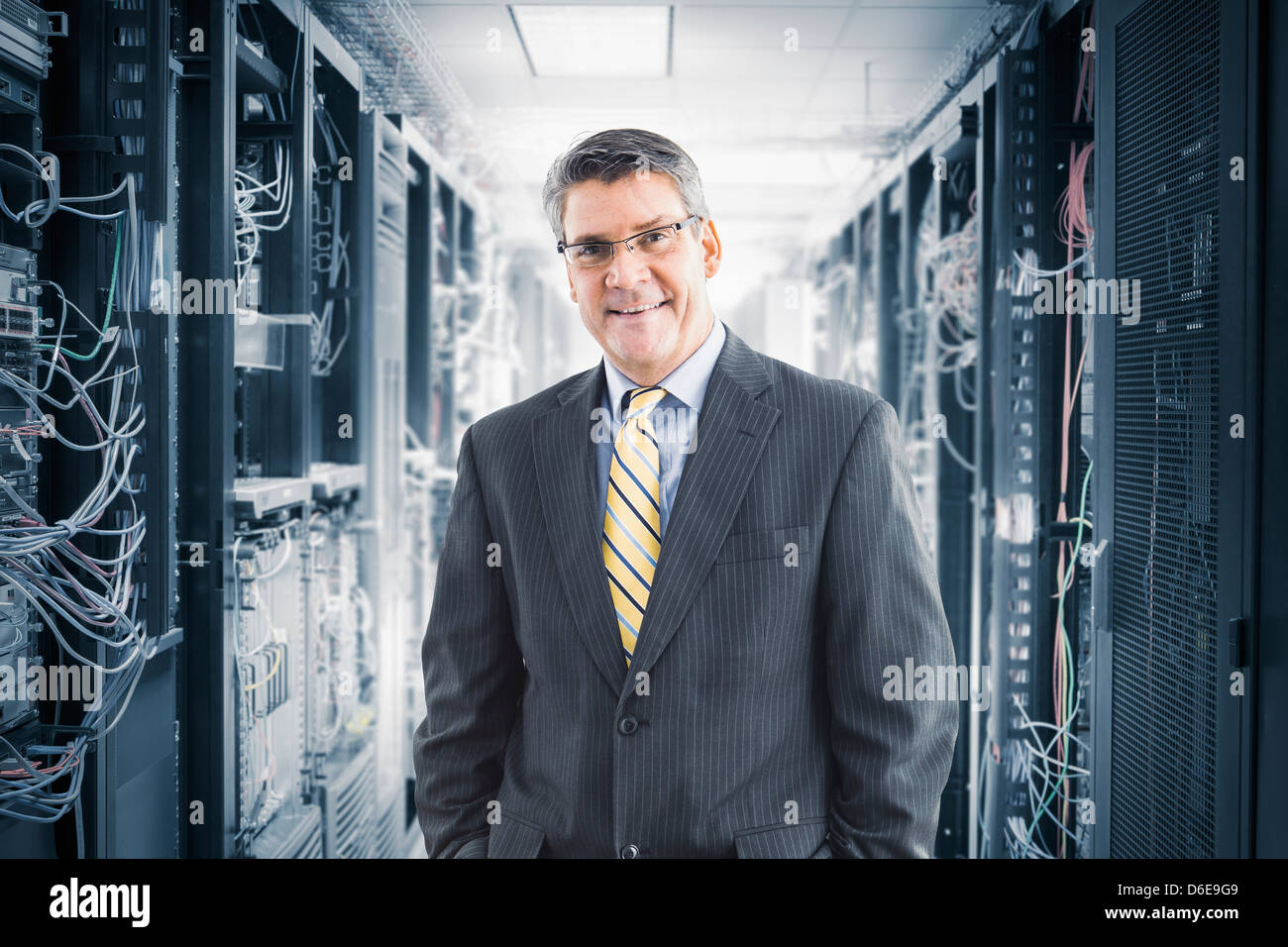 Caucasian businessman smiling in server room Stock Photo - Alamy