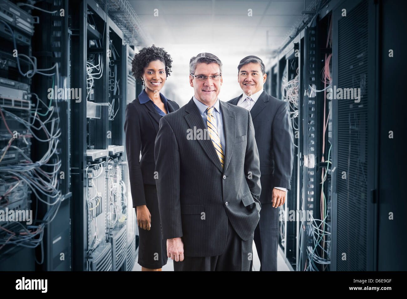 Businesspeople smiling in server room Stock Photo - Alamy