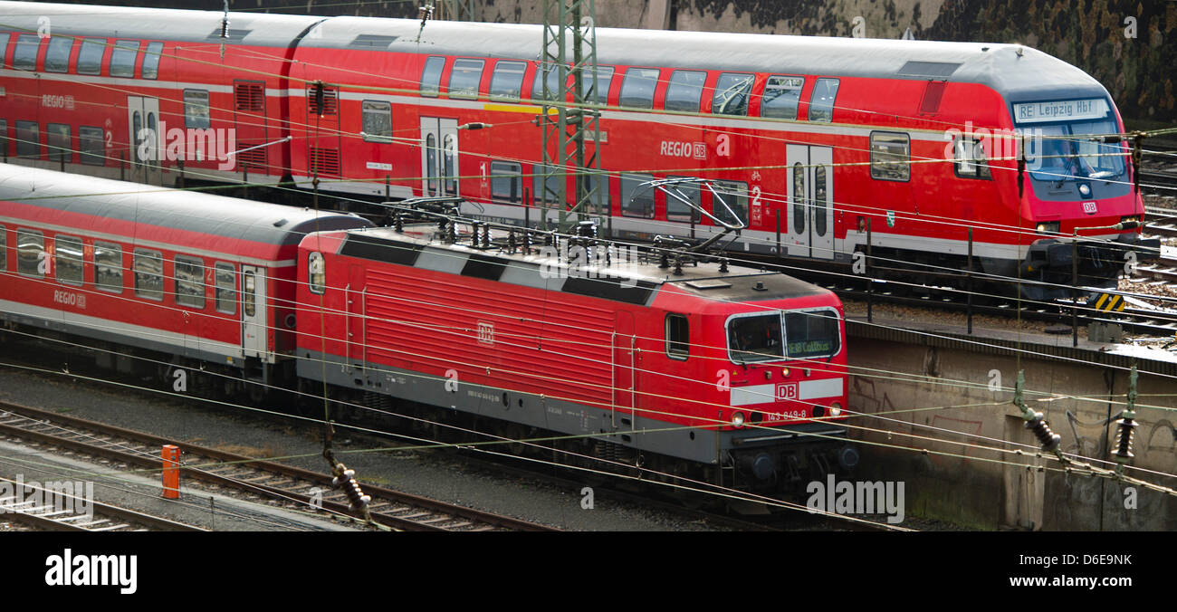 Trains of the German railway company Deutsche Bahn (DB), leave the main ...