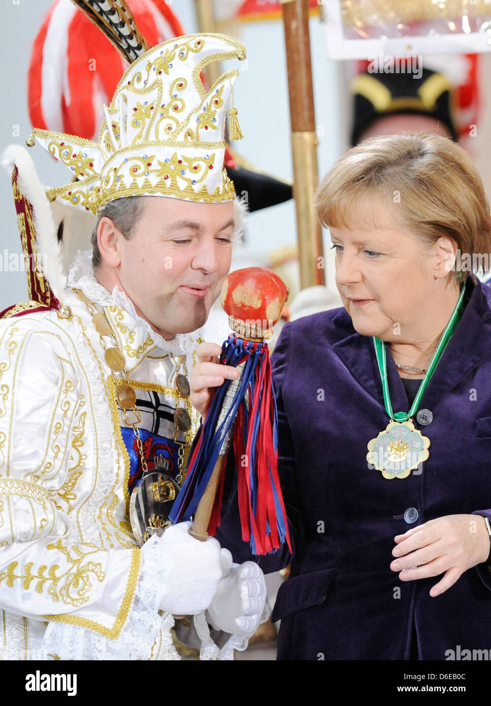 German Chancellor Angela Merkel looks at the scepter of carneval prince ...