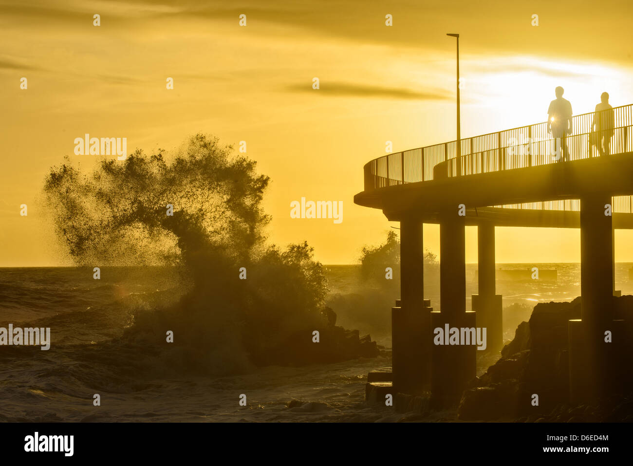 Silhouette of people on bridge over rough sea in Madeira, Portugal ...