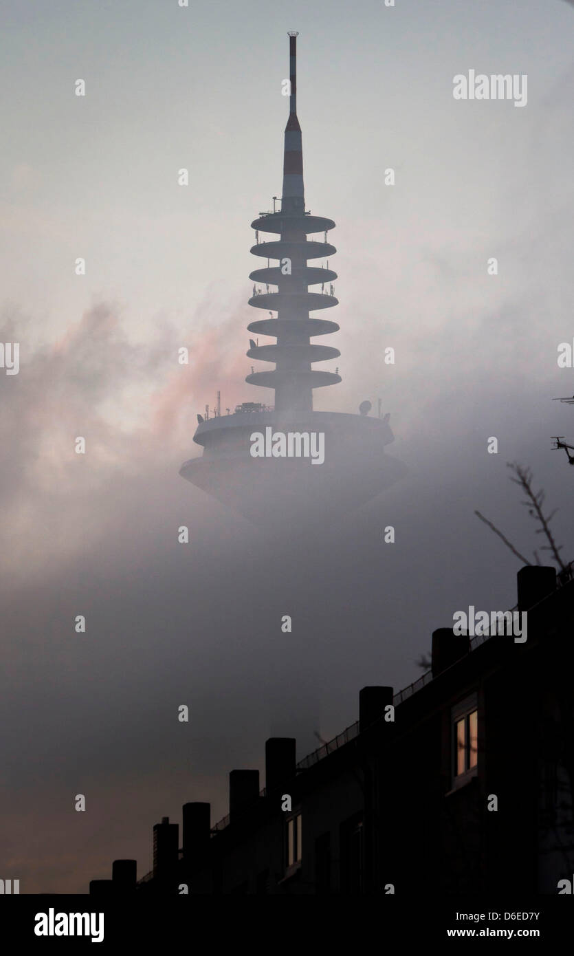 The tip of the Europe Tower looks like an UFO above a layer of fog and ...