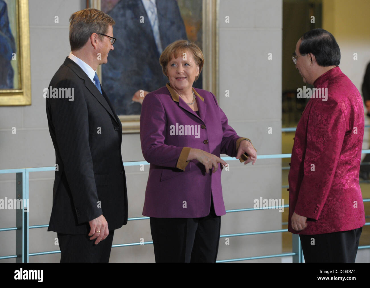 German Chancellor Angela Merkel (C) and German Foreign Minister Guido ...