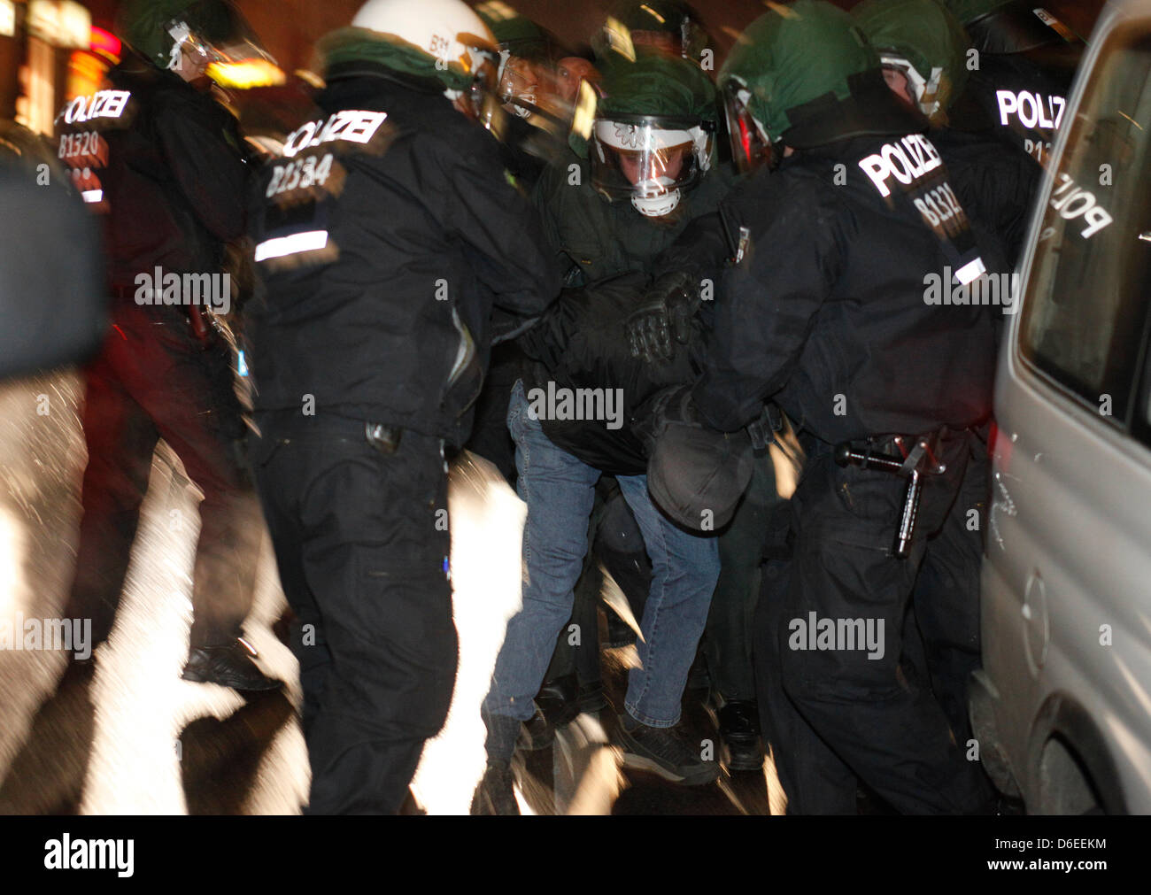 Police officers take demonstrators into custody during a demonstration ...