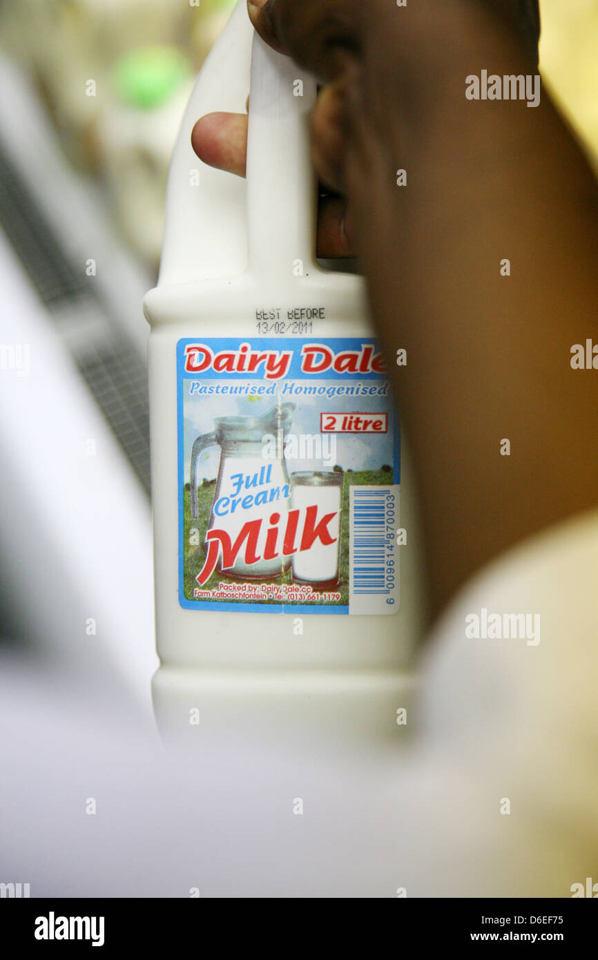 African hands reaching for fresh bottled milk Stock Photo - Alamy