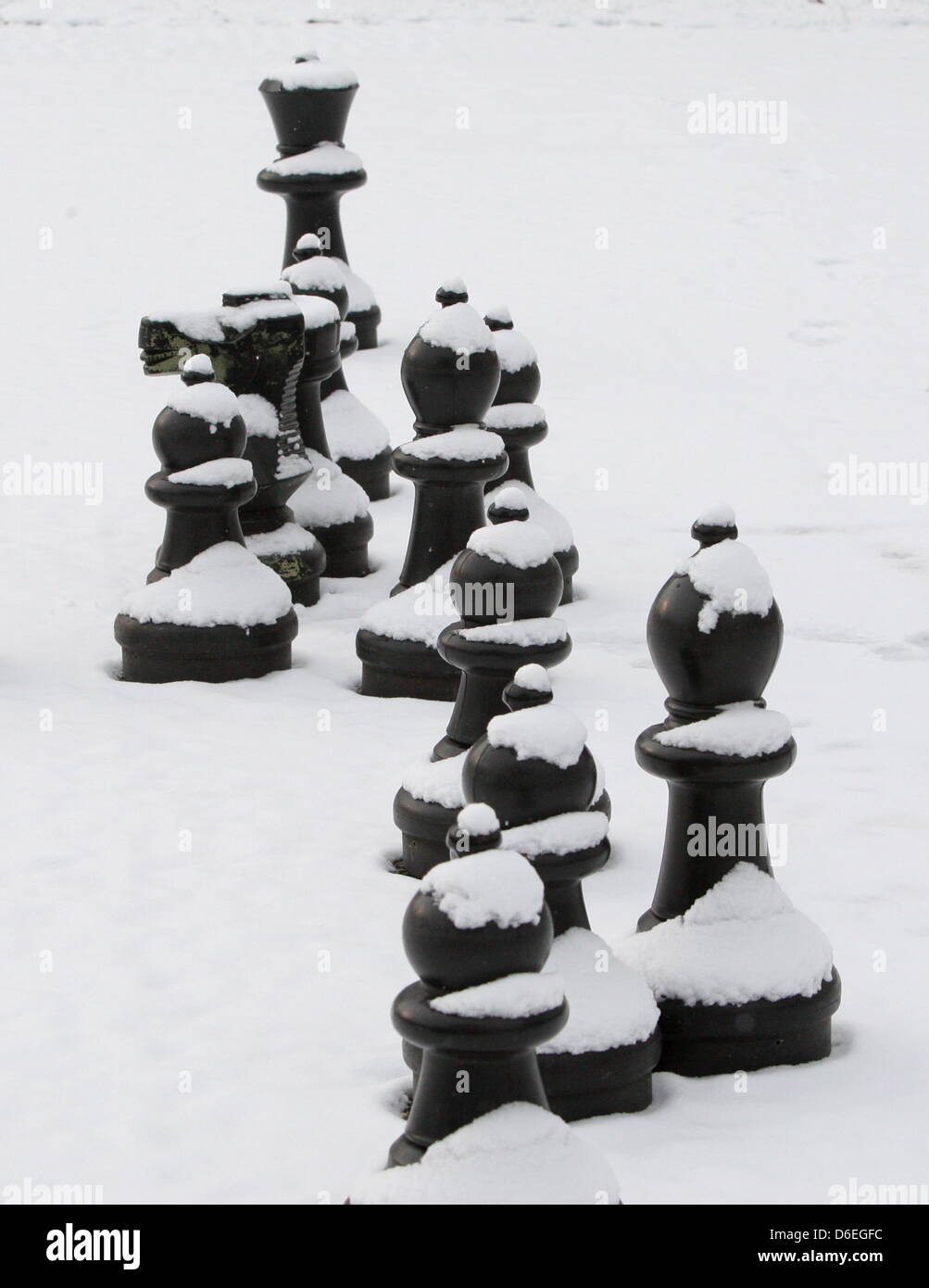 Chess figures are covered with snow in the Castle park in Stuttgart ...