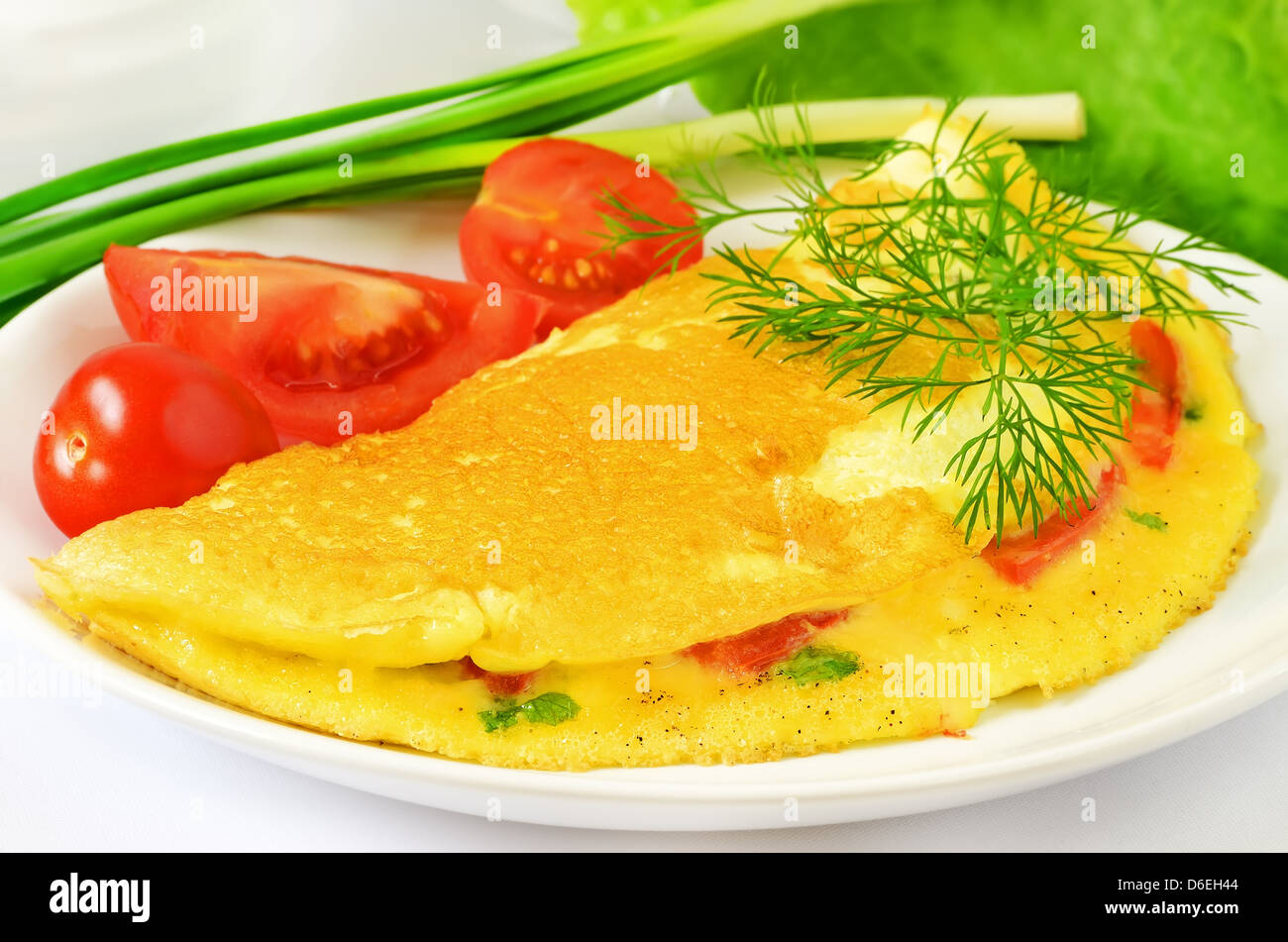 Omelet with herbs and vegetables on the plate Stock Photo - Alamy