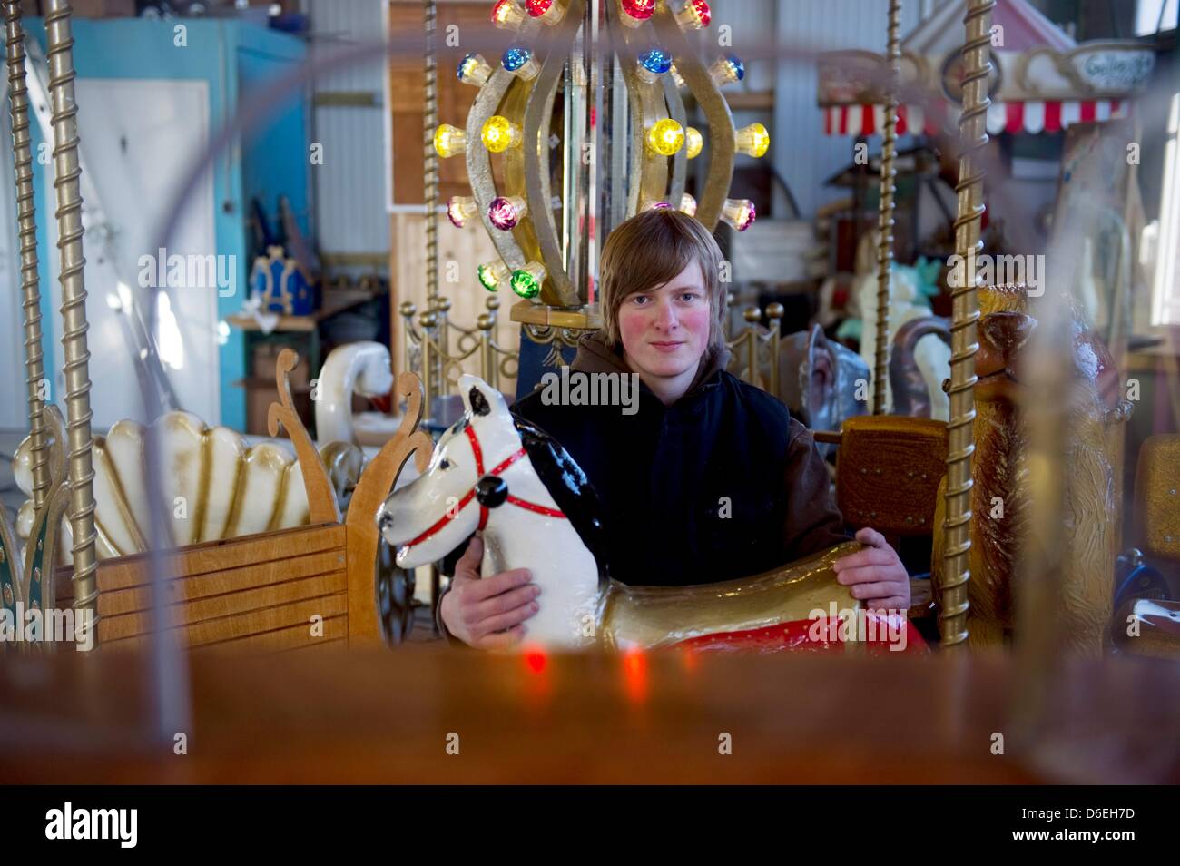 Carousel builder John Heinz kneels at one of his carousels in Breidenbach-Oberdieten, Germany ...