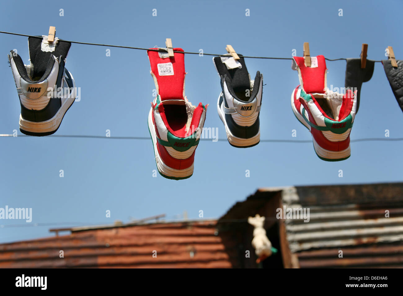 Children's shoes dry on a wash line outside a shack home in Botleng ...