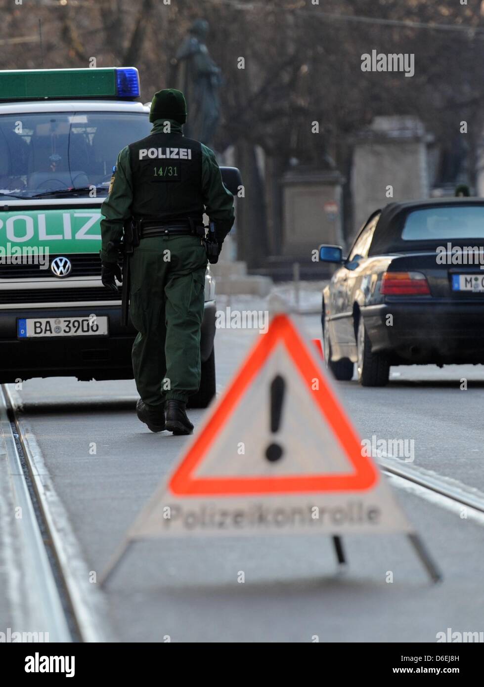 A sign with the lettering police check is featured at a street leading ...