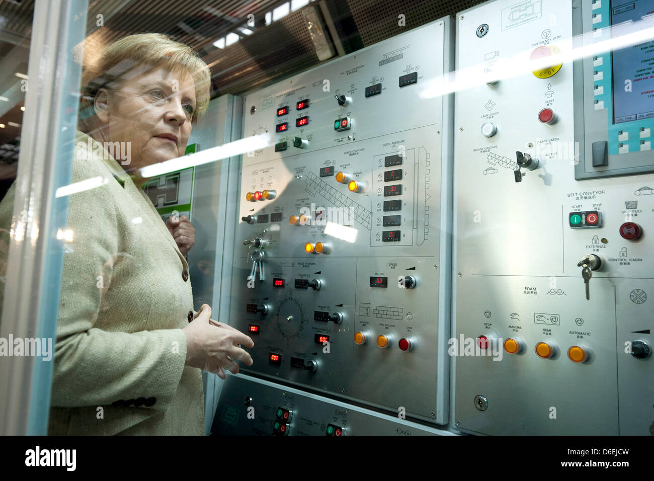 German Chancellor Angela Merkel stands in a control room of a tunnel ...